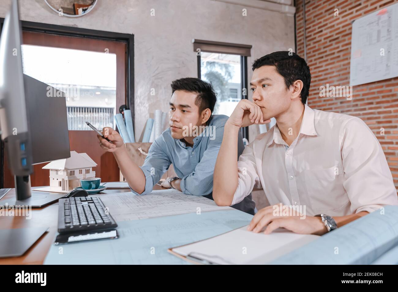 engineers and architect reading a building and drawing outlay ...