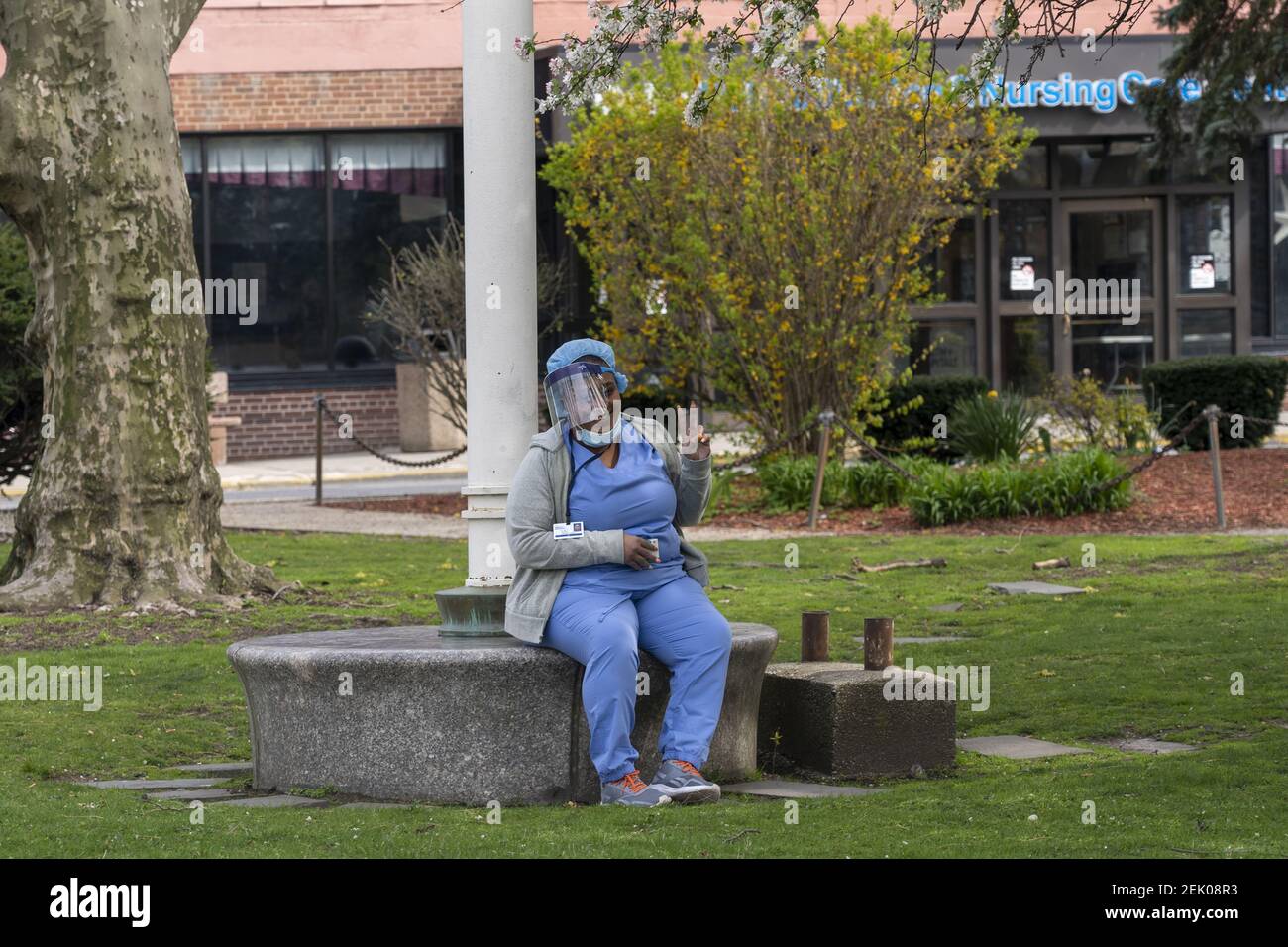 A nurse wearing a personal protective equipment (PPE) takes a break ...