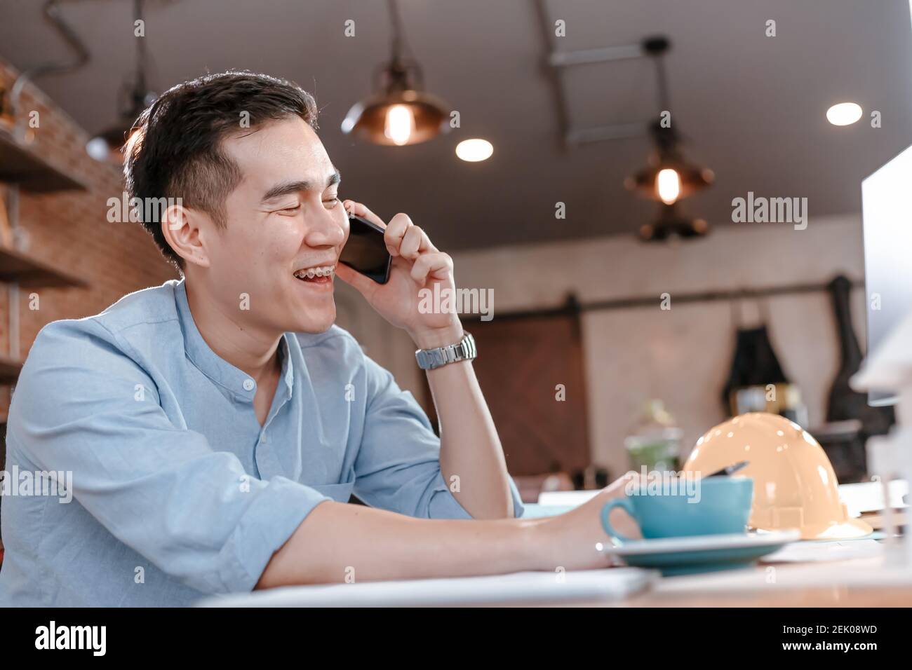 architect use mobile phone call with enginner and reading a building ...