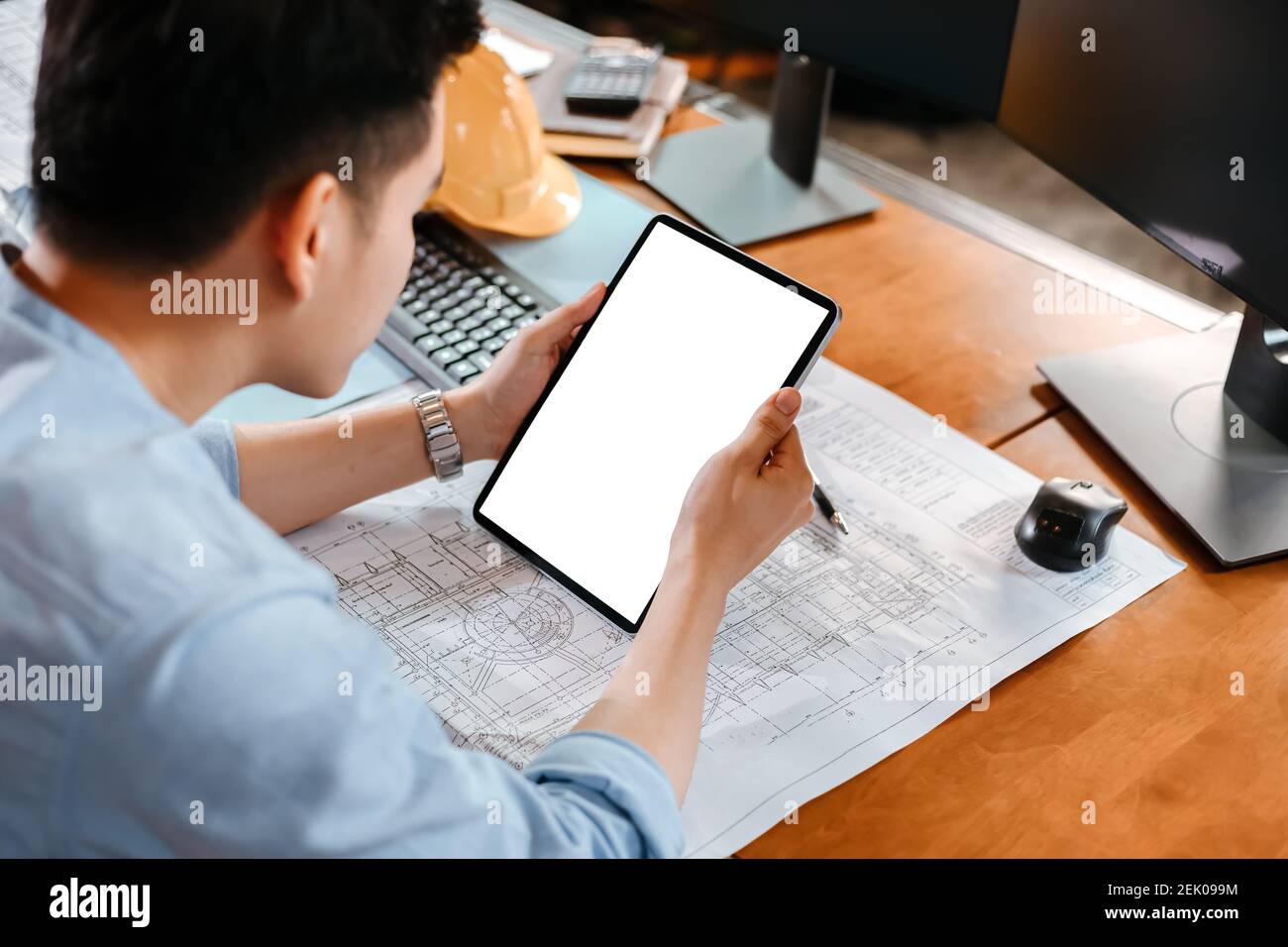 Architect reading building and drawing outlay construction plan as ...