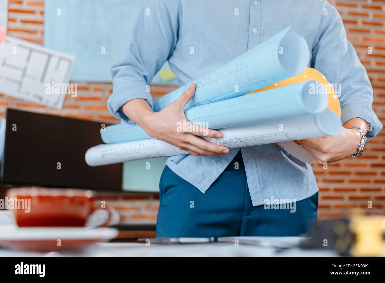 engineer hold engineer drawing design blueprints and safety helmet in ...