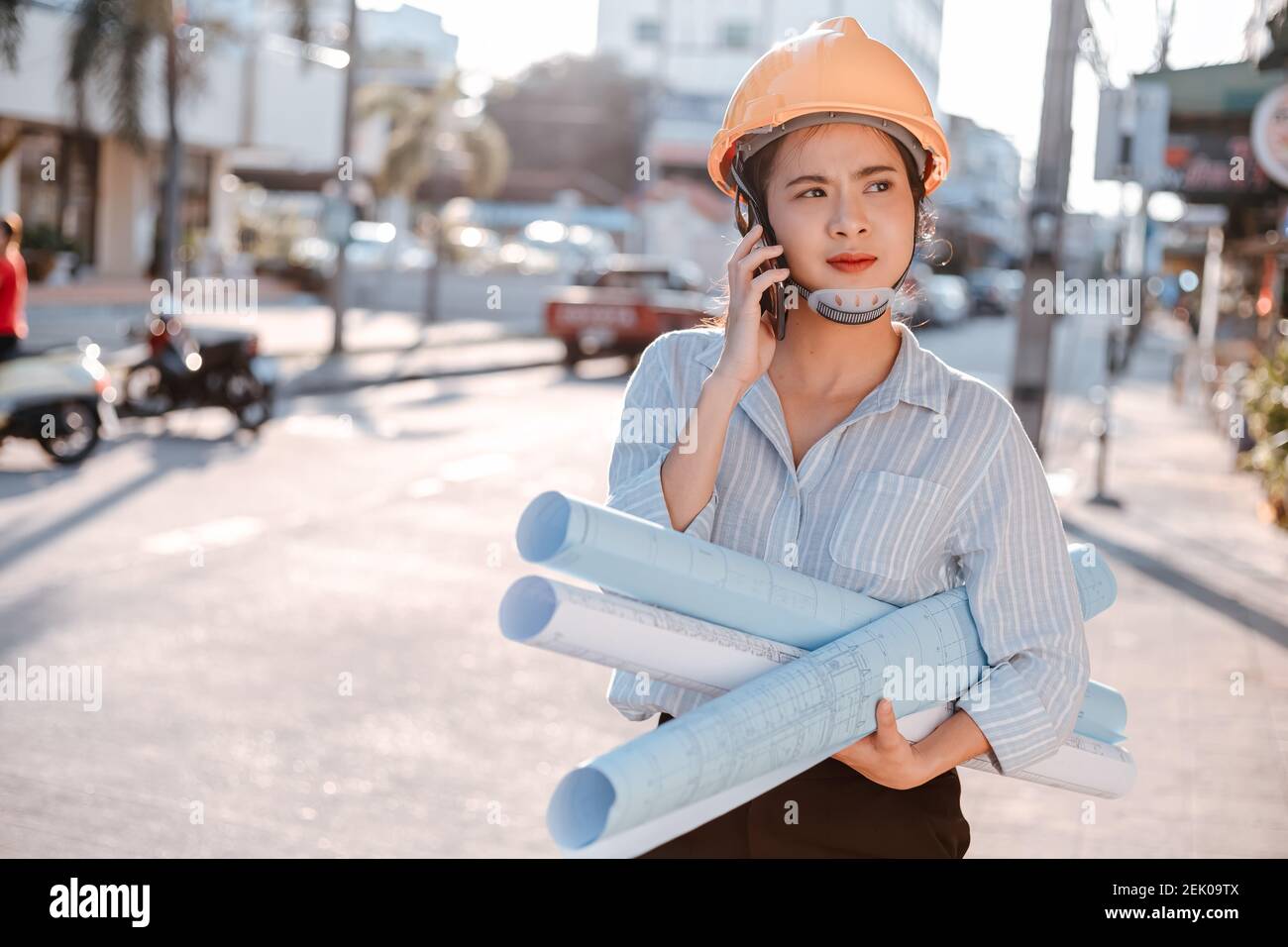 architect woman use mobile phone call with enginner or project manager ...