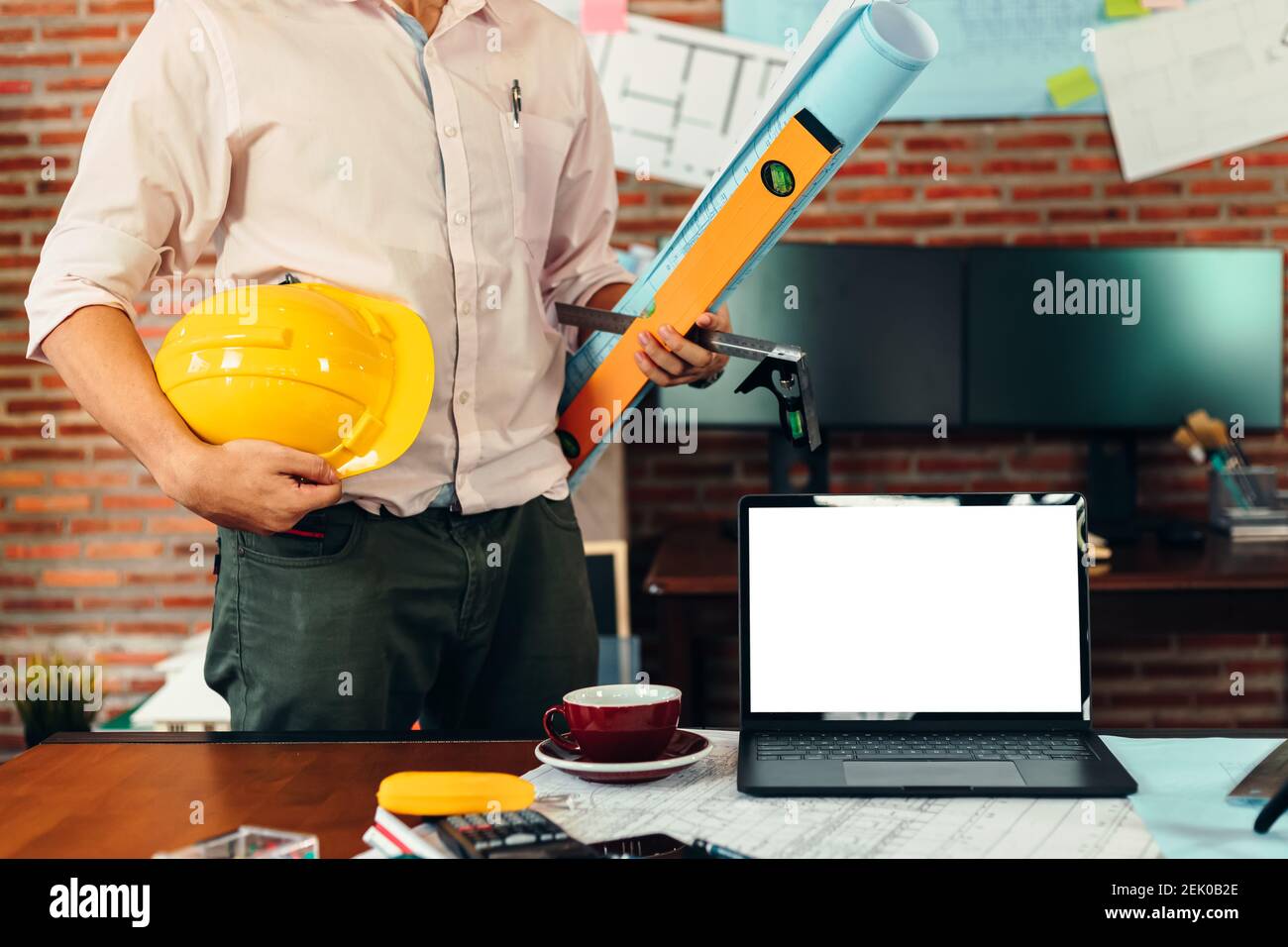 engineer hold engineer drawing design blueprints and safety helmet in ...