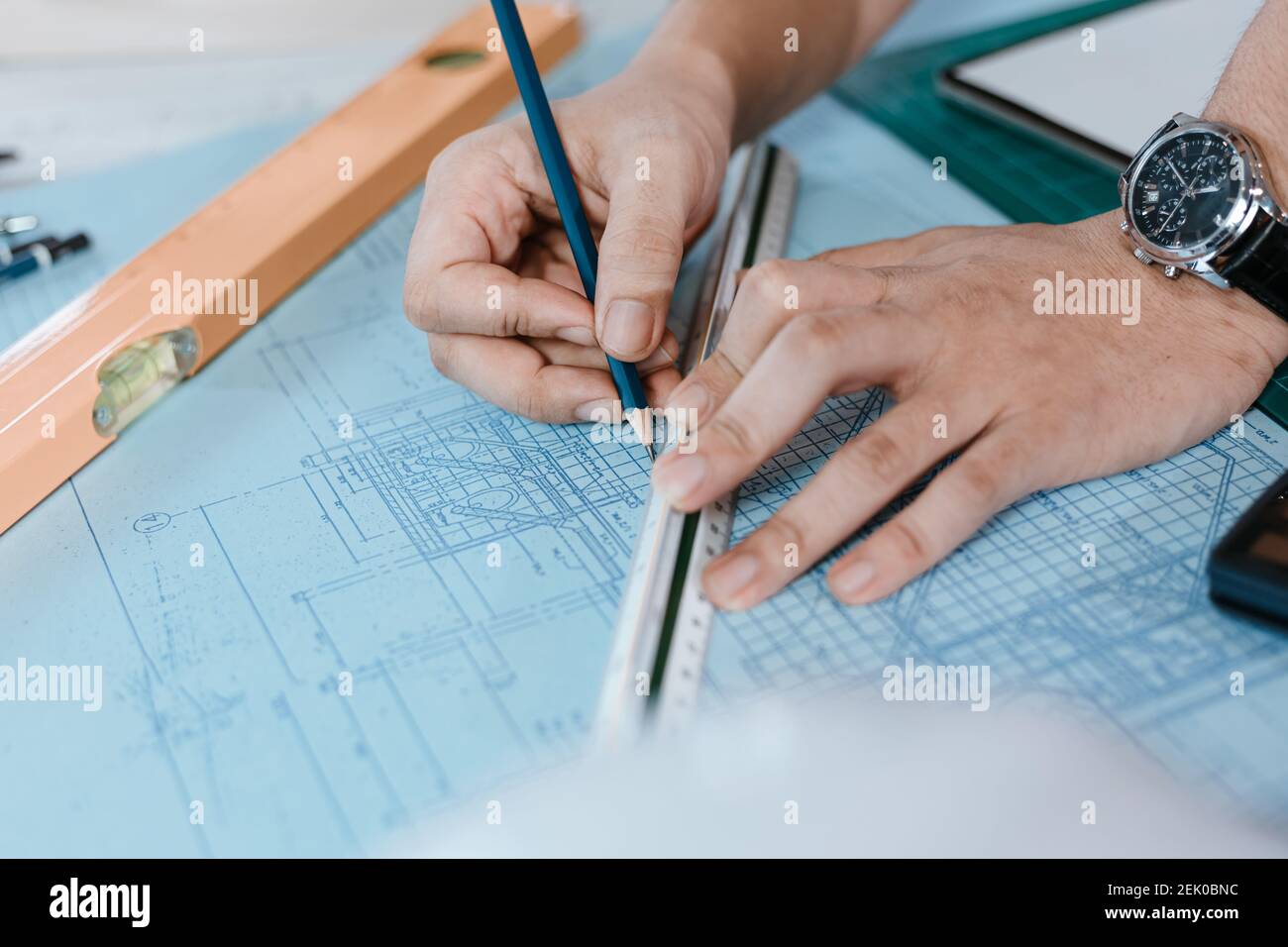 Construction helmet holding blueprints writing hi-res stock photography ...