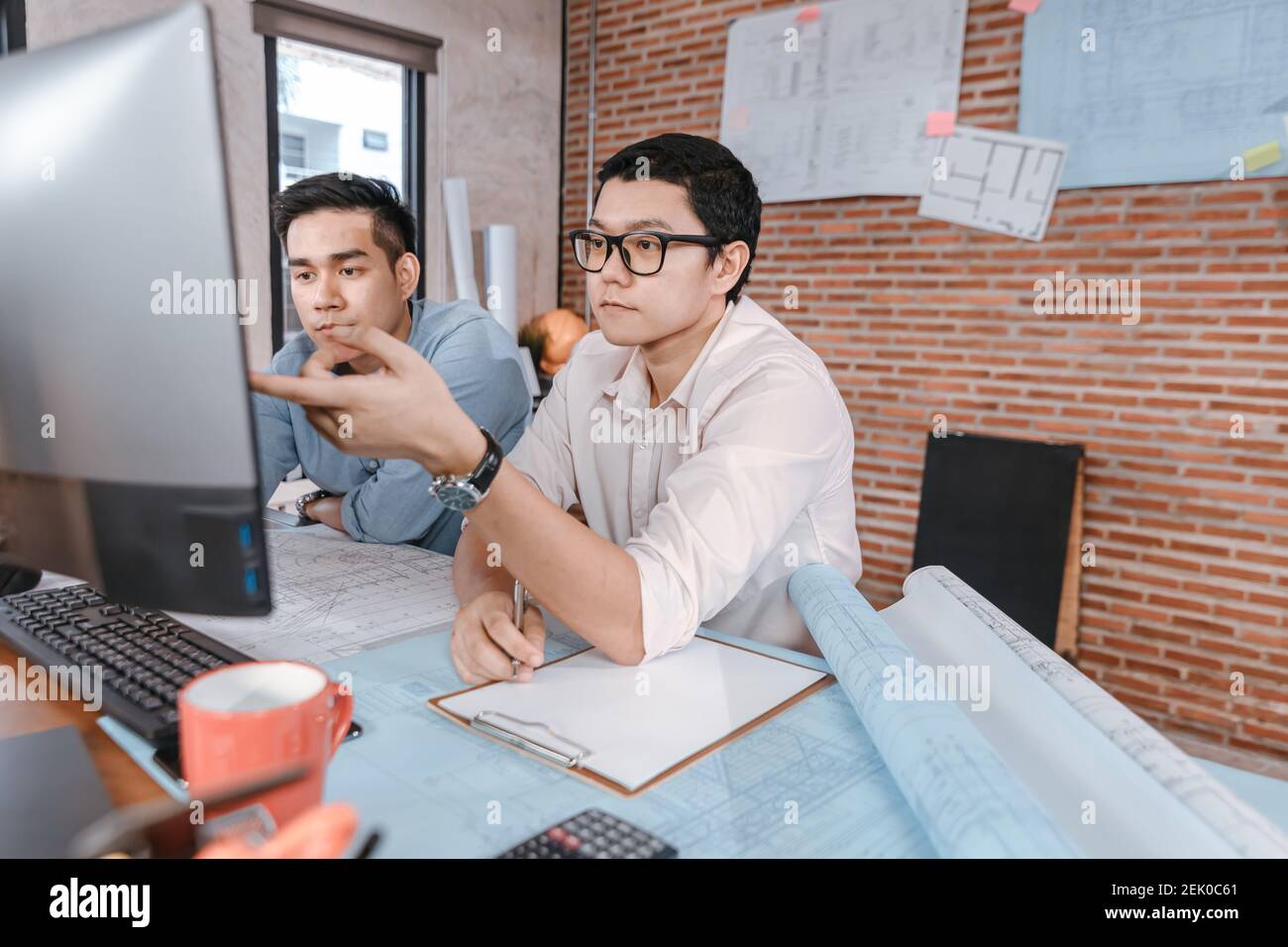 engineers and architect reading a building and drawing outlay ...