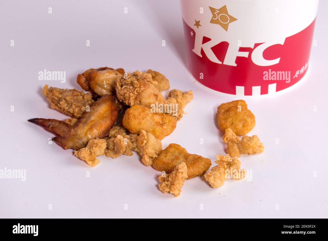 In this unlocated photo, a bucket meal, including chicken nuggets, fried drumstick, chicken ...