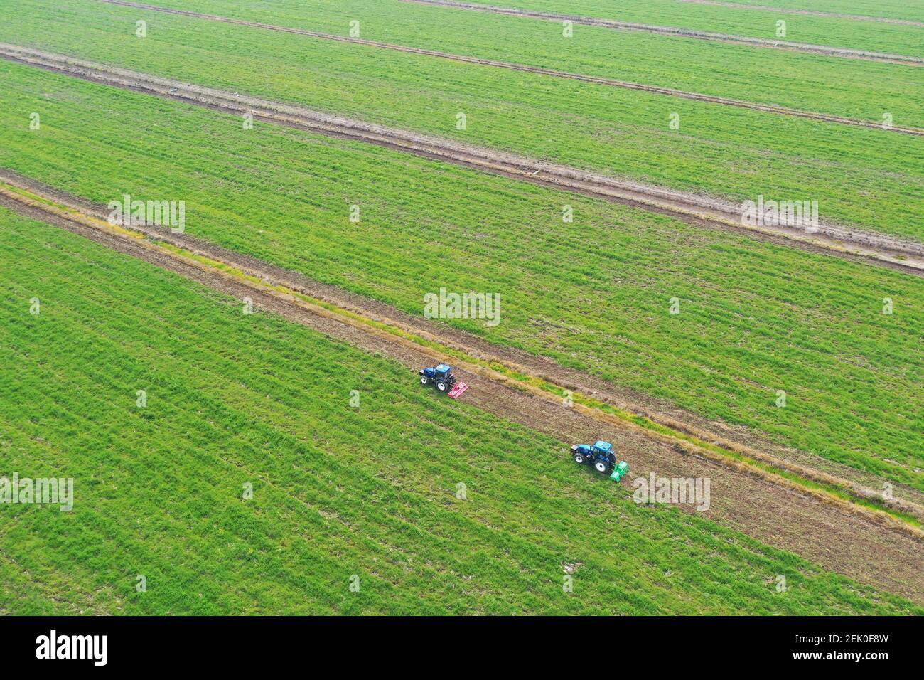 An aerial view of agricultural machines taking the chance of spring ...
