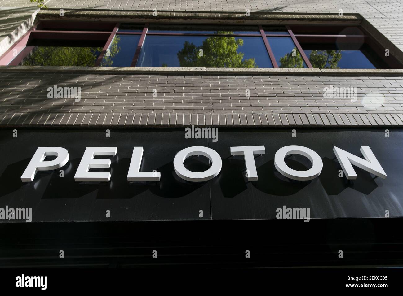 A logo sign outside of a Peloton retail store in Bethesda, Maryland on ...