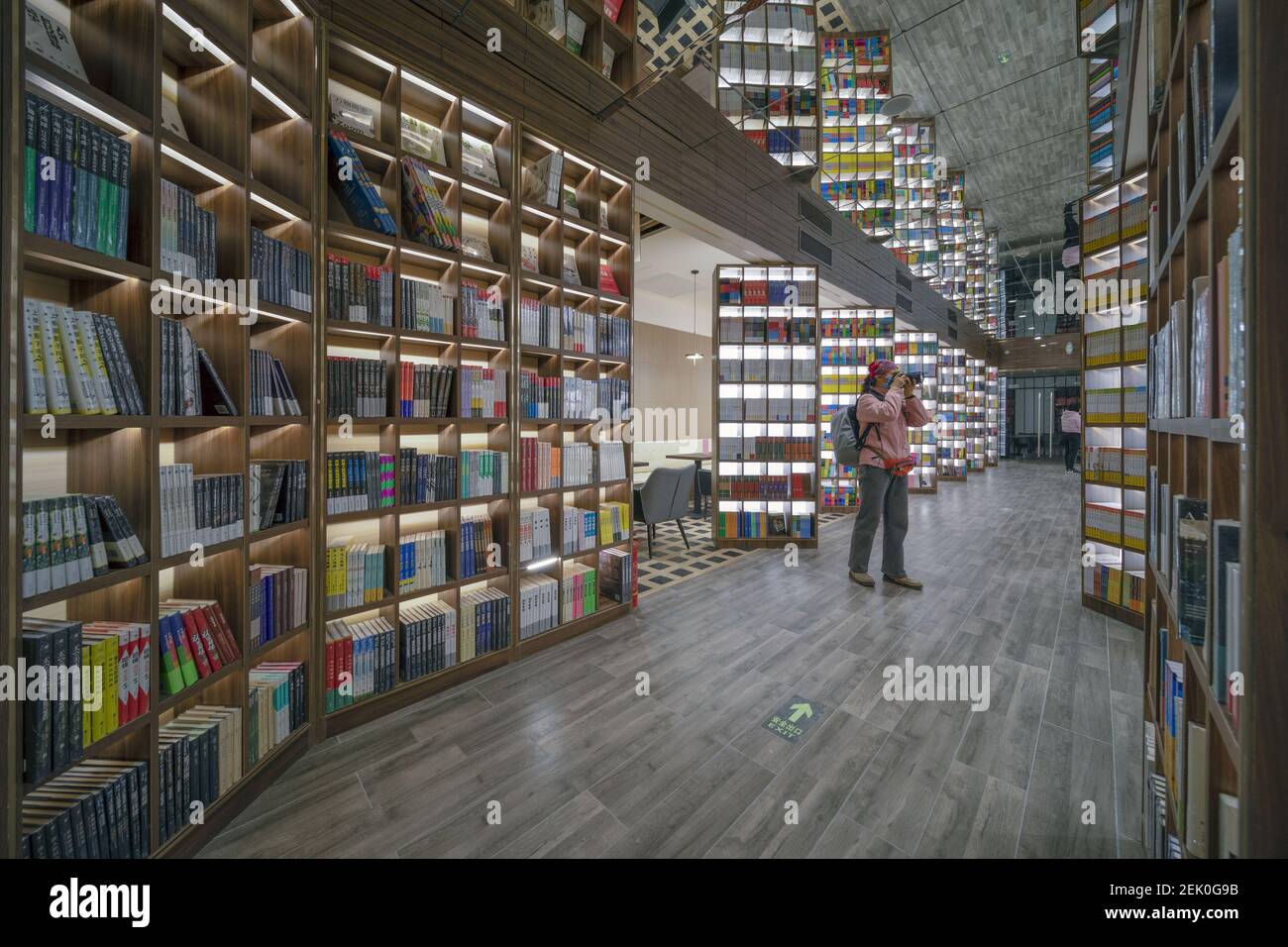 A person takes photos in Zhongshuge bookstore, one of Chinese bookstore ...