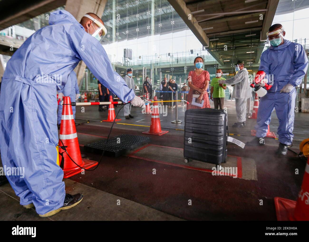 Soldiers dressed in protective suits as a preventive measure guiding ...