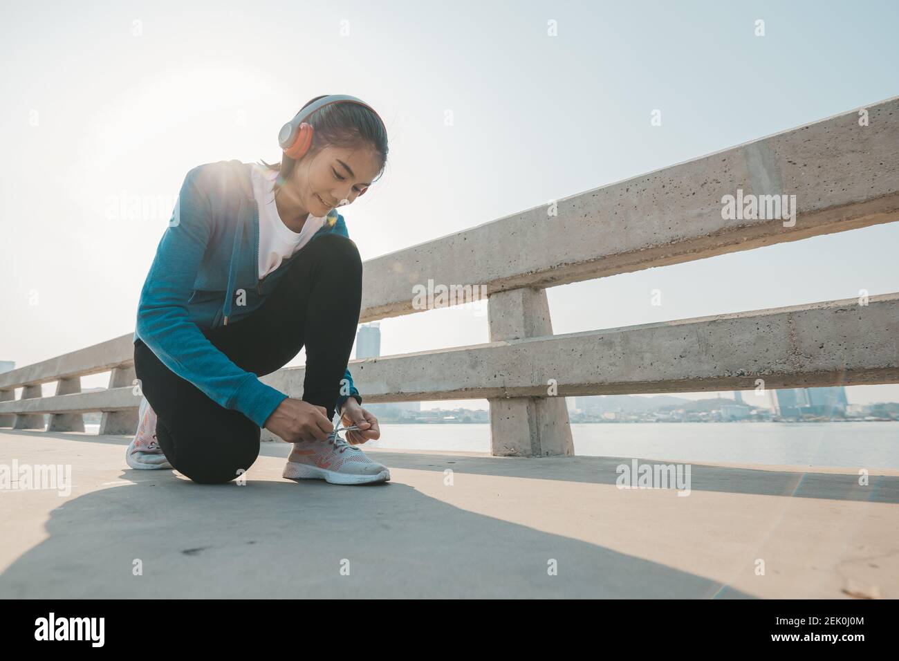 Woman tying shoe laces. Woman fitness runner get ready for jogging on ...