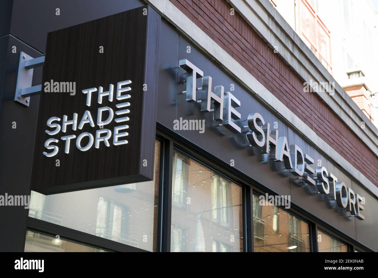 A logo sign outside of a The Shade Store retail store location in ...