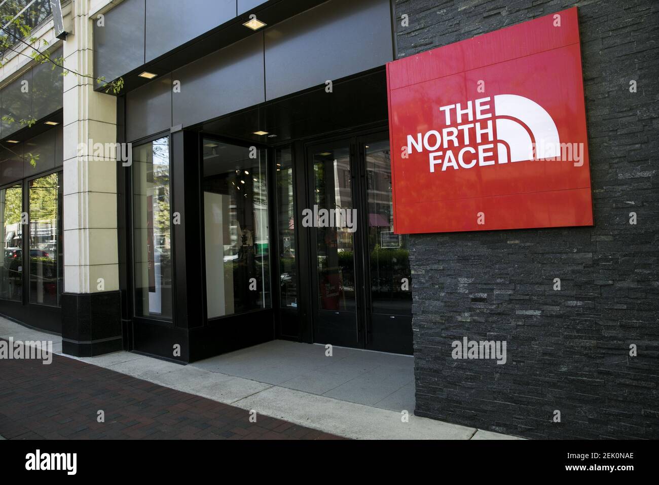 A logo sign outside of a The North Face retail store location in ...