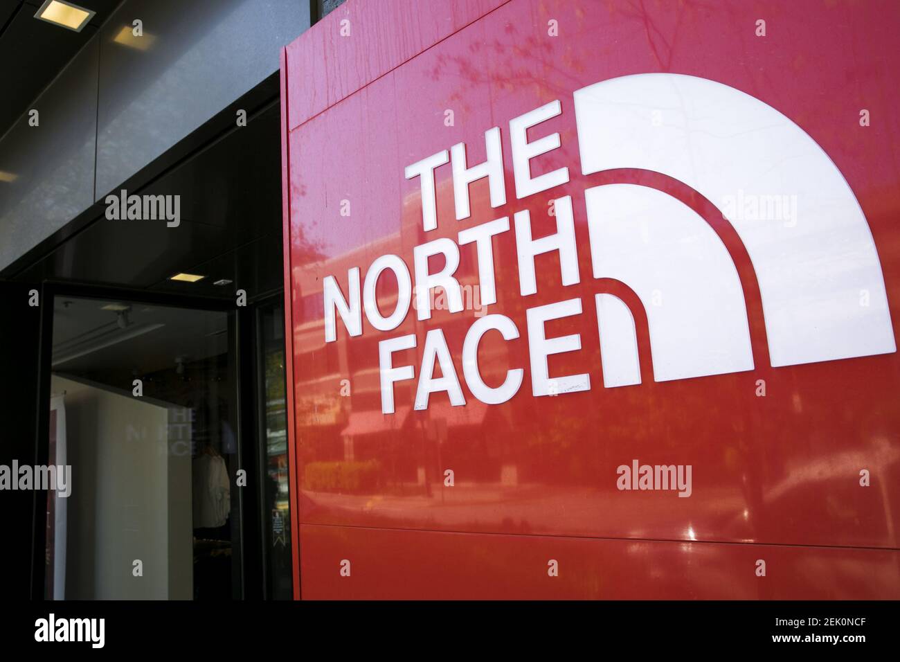 A logo sign outside of a The North Face retail store location in ...
