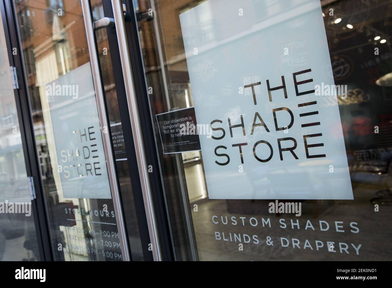 A logo sign outside of a The Shade Store retail store location in ...