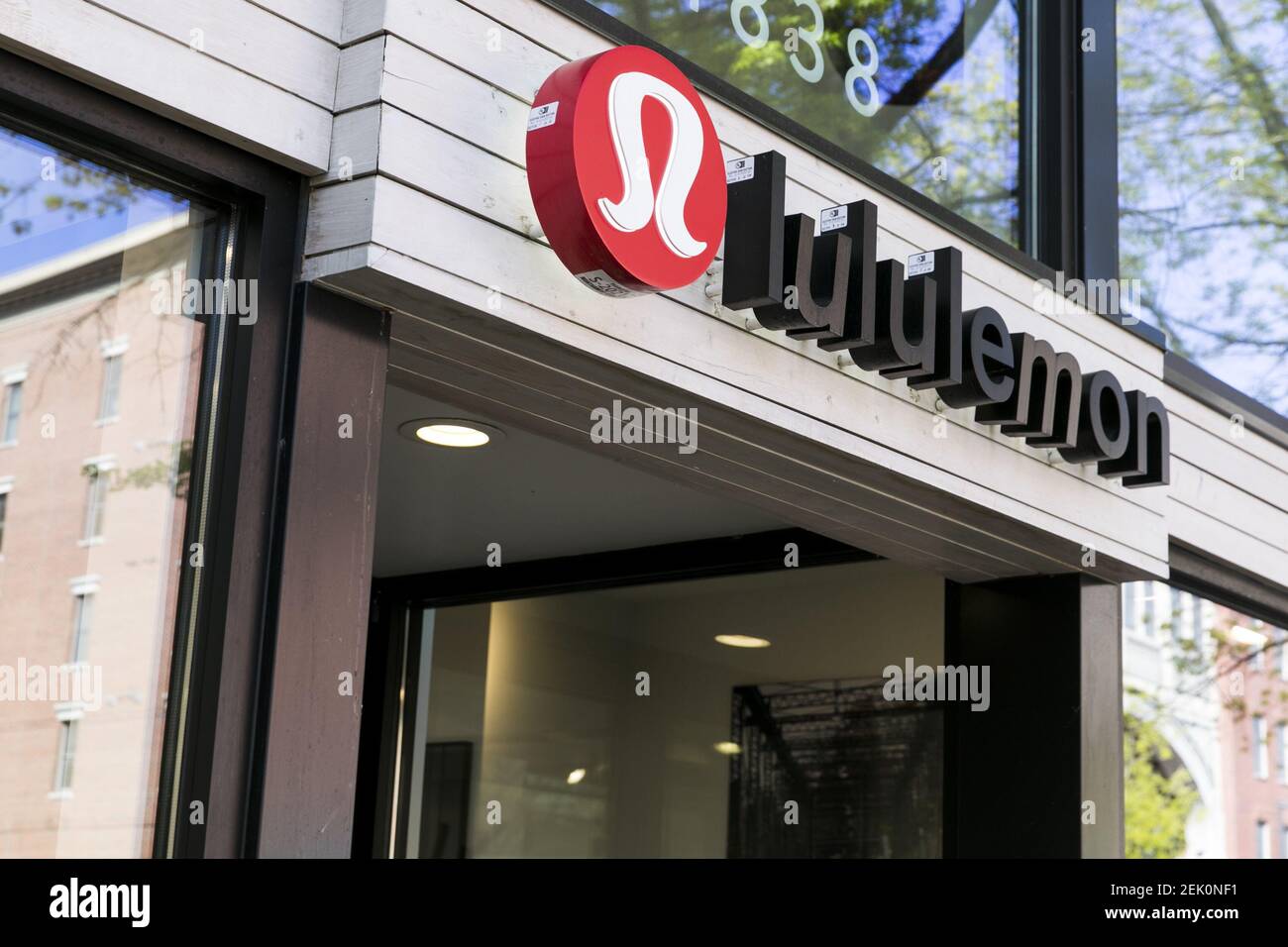 A logo sign outside of a Lululemon Athletica retail store location in ...