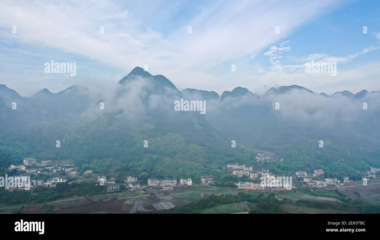 XINGYI, CHINA - APRIL 26, 2020 - Wanfeng forest is surrounded by clouds ...