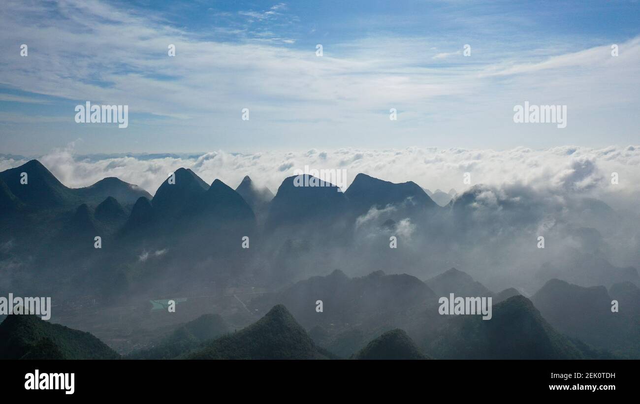 XINGYI, CHINA - APRIL 26, 2020 - Wanfeng forest is surrounded by clouds ...