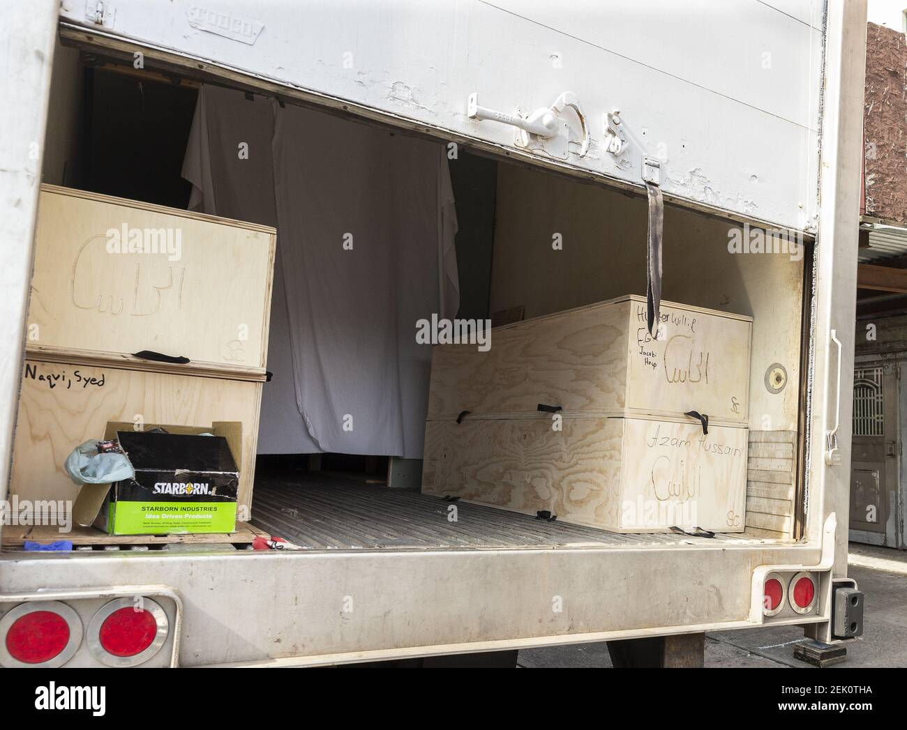 Caskets seen inside refridgerated trailer parked at Al-Rayaan Funeral ...