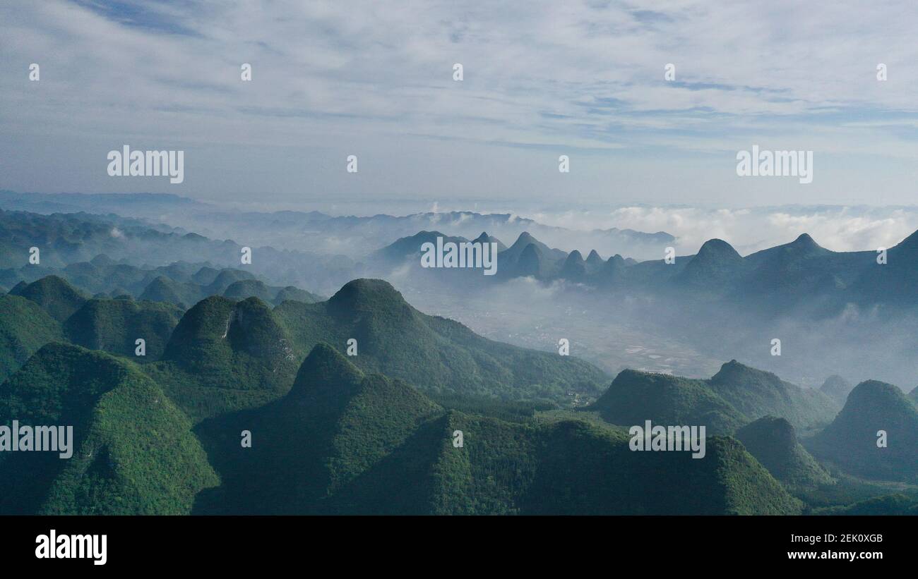 XINGYI, CHINA - APRIL 26, 2020 - Wanfeng forest is surrounded by clouds ...