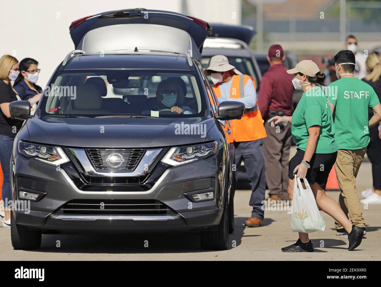 City of Hialeah employees load up food and vegetables to hundreds of ...