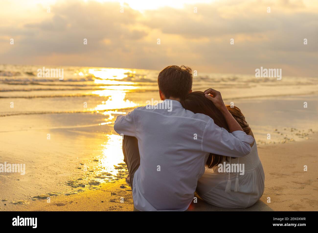 Couple in love watching sunset together on the beach travel summer ...