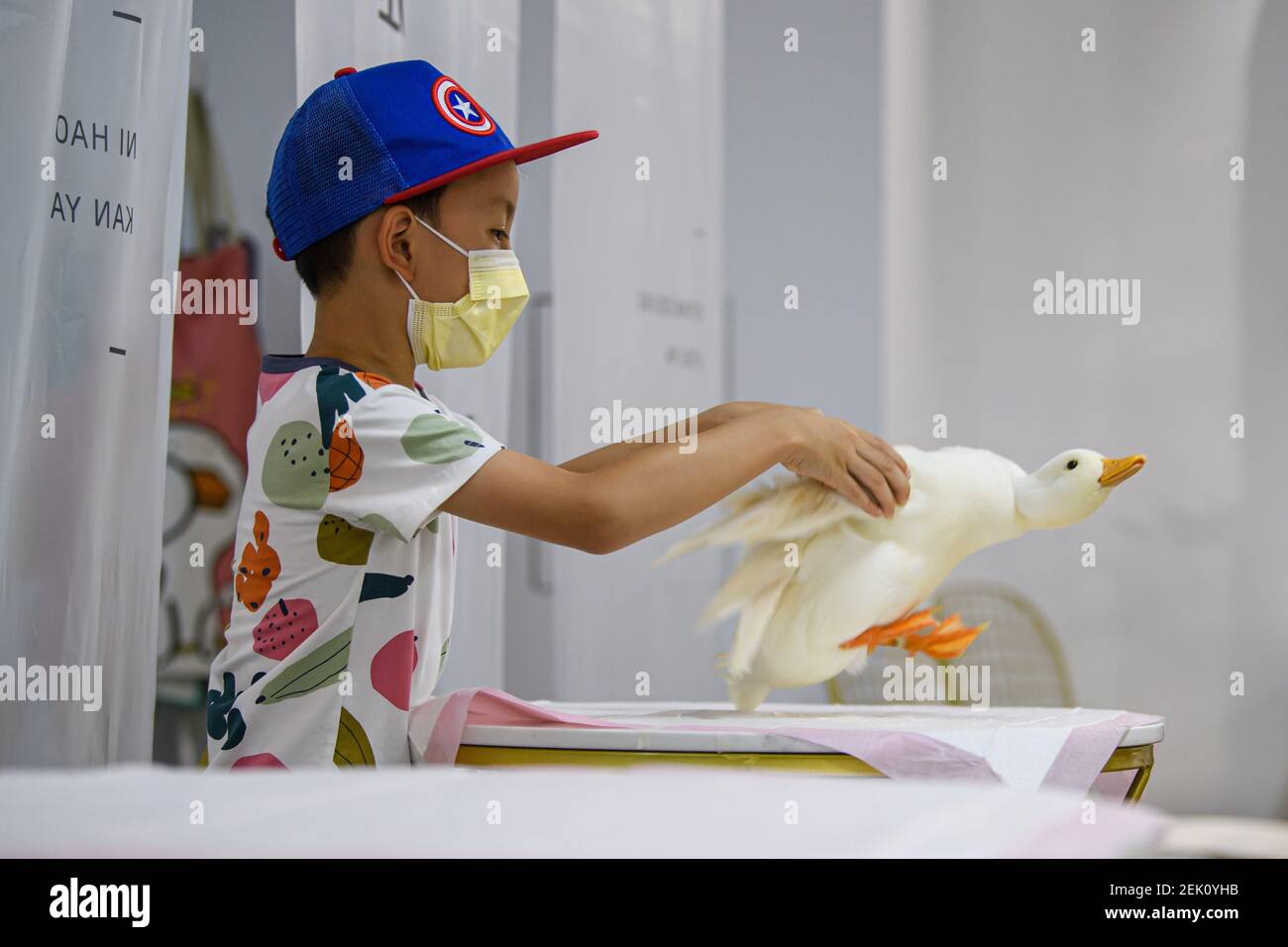 A kid plays with a cole duck in a cole duck experience store in ...