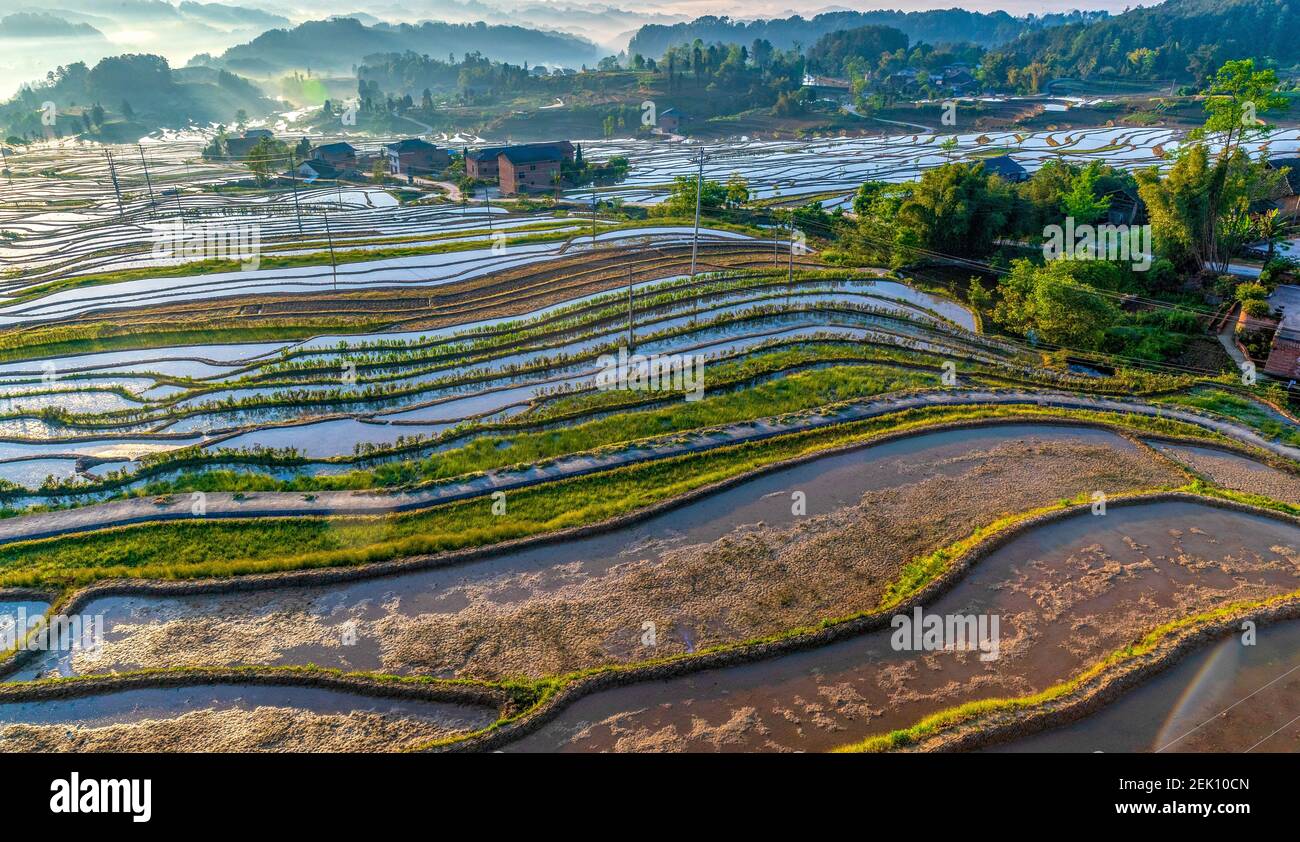 An aerial view of terraces on a hill near a small mountain village ...