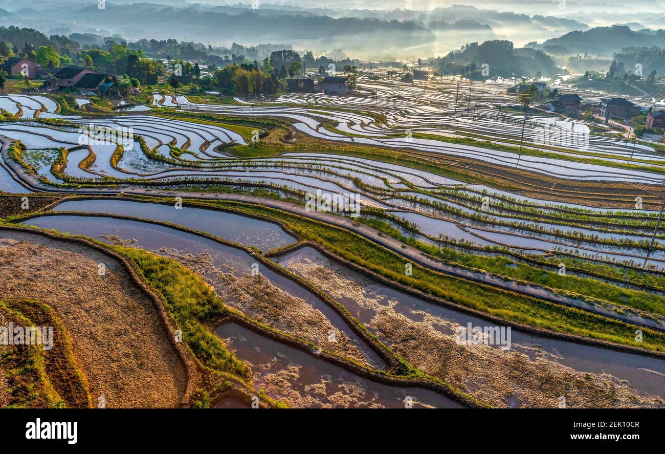 An aerial view of terraces on a hill near a small mountain village ...