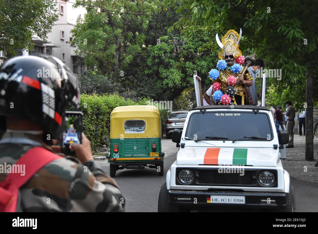 A man takes photos of an artist dressed as Yamraj also known as the God ...