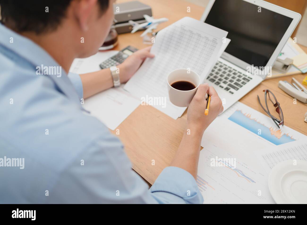 Businessman drink coffee and working data document report marketing ...