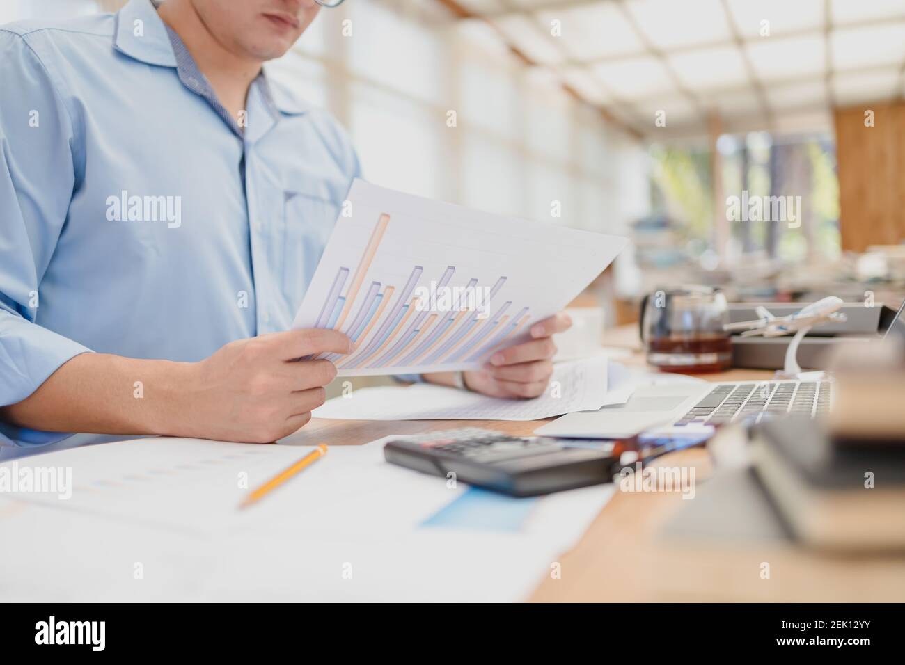 Businessman hold paper graph and checking document data calculator for ...