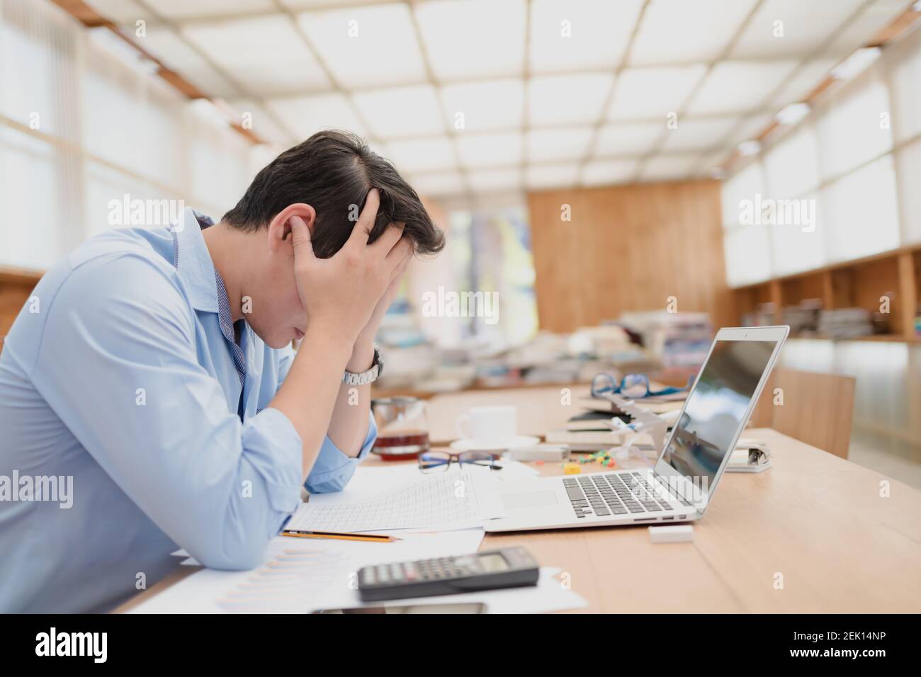 Tired businessman at workplace in office holding his headache or angry ...