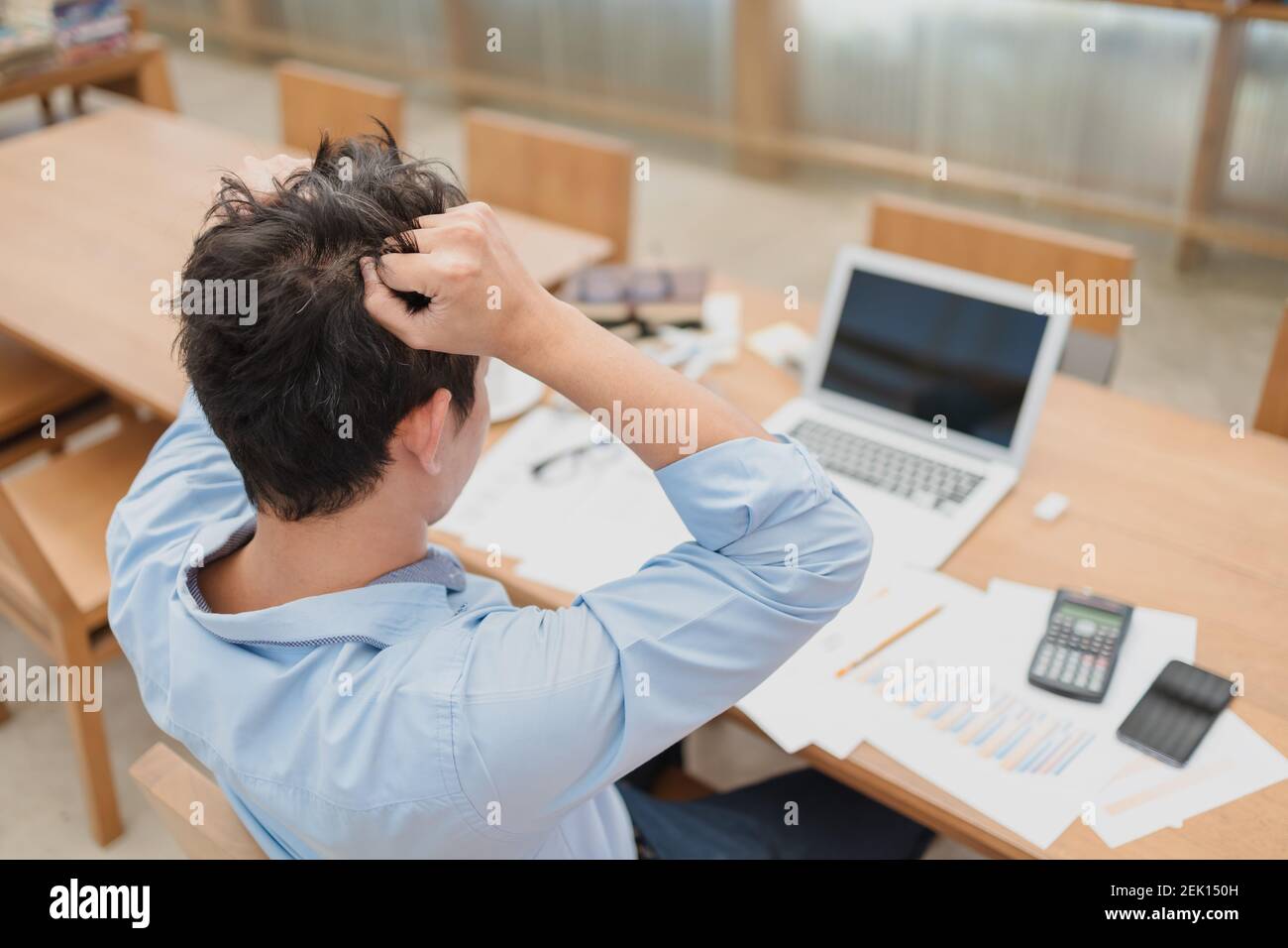 Tired businessman at workplace in office holding his headache or angry ...