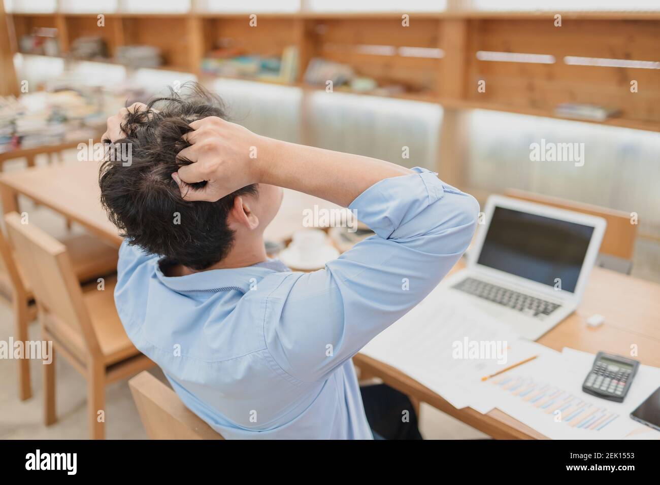 Tired businessman at workplace in office holding his headache or angry ...