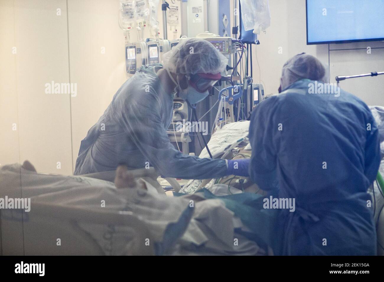 Health workers wearing protective gear as a precaution assist a COVID19 ...