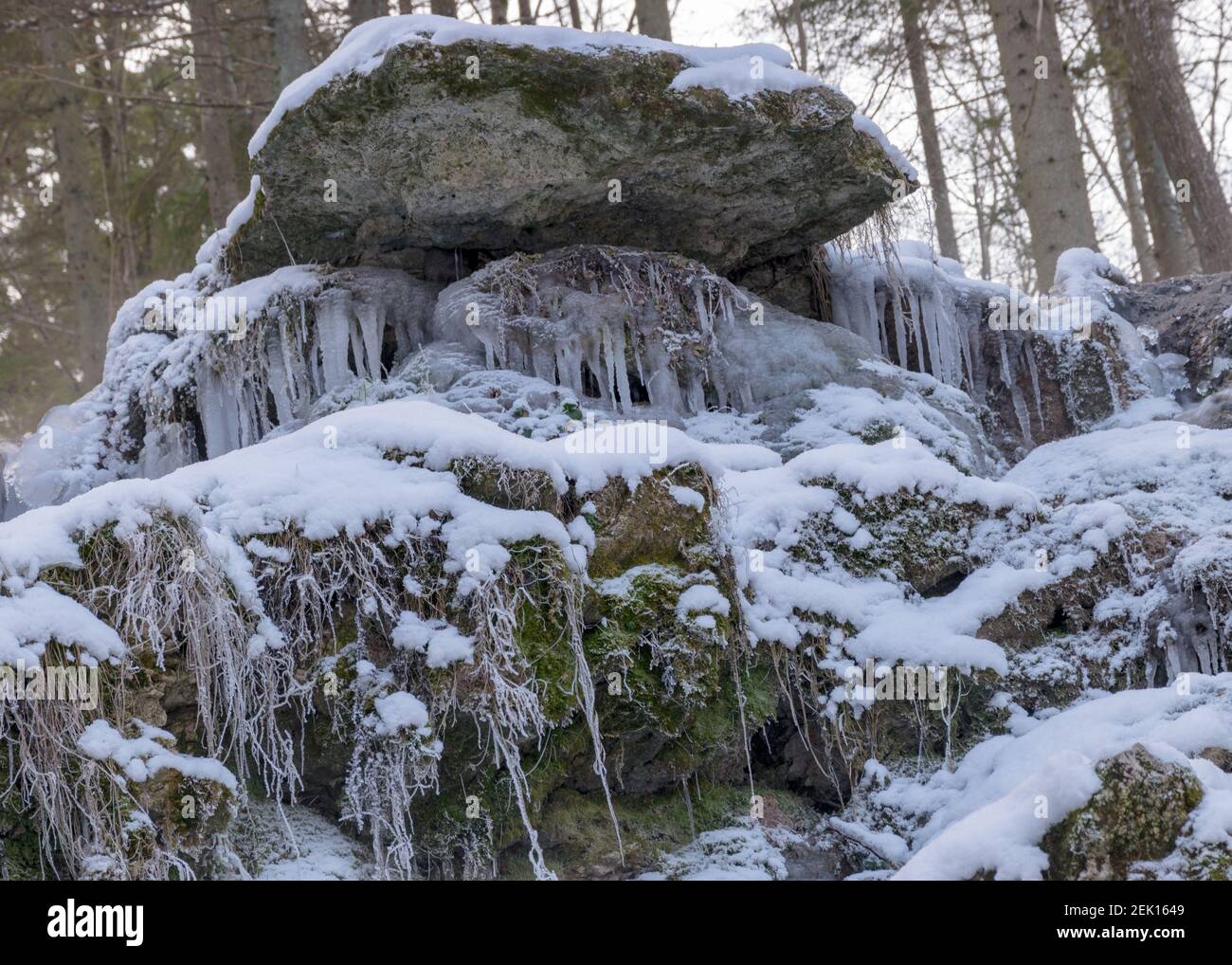 frozen fast flowing spring water, icy rocks and water stream, frosty ...