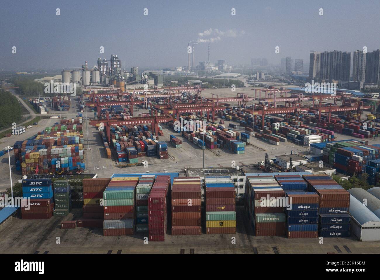 Containers are arrayed waiting to be delivered by cargo vessels at a ...