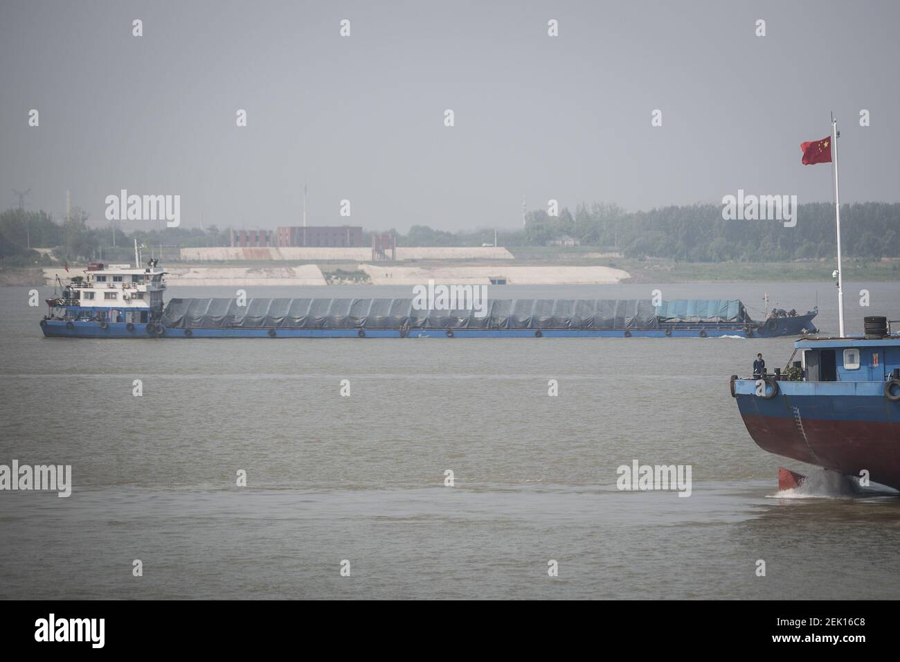 Cargo vessels with containers drive into and out the port at a port ...