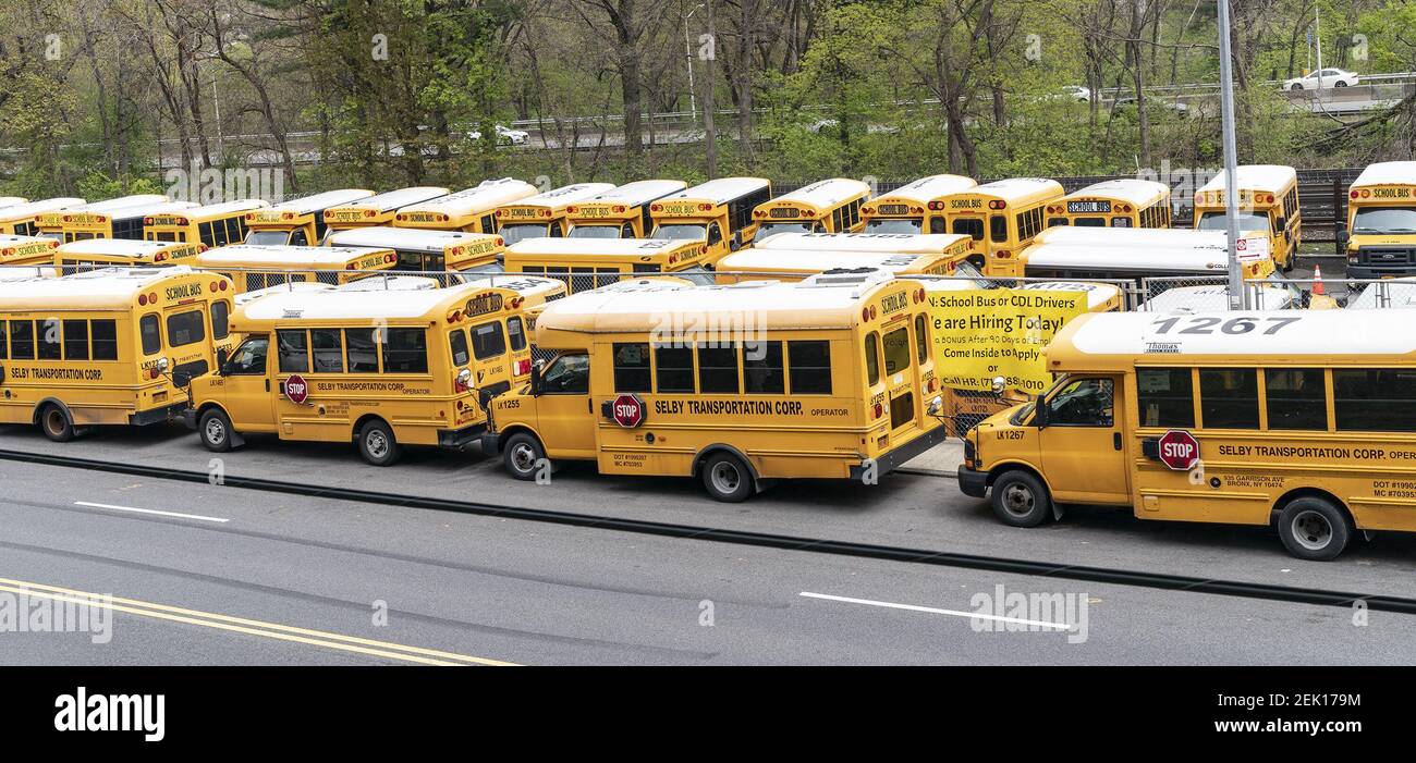 School buses stand idle on the parking lot of the Bronx borough during ...