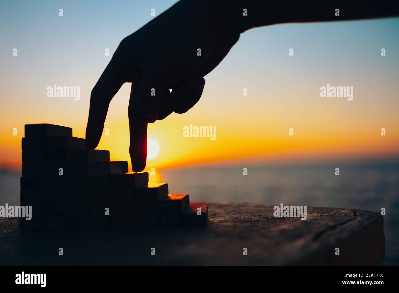 finger like a person stepping up wood block stacking as step stair and ...
