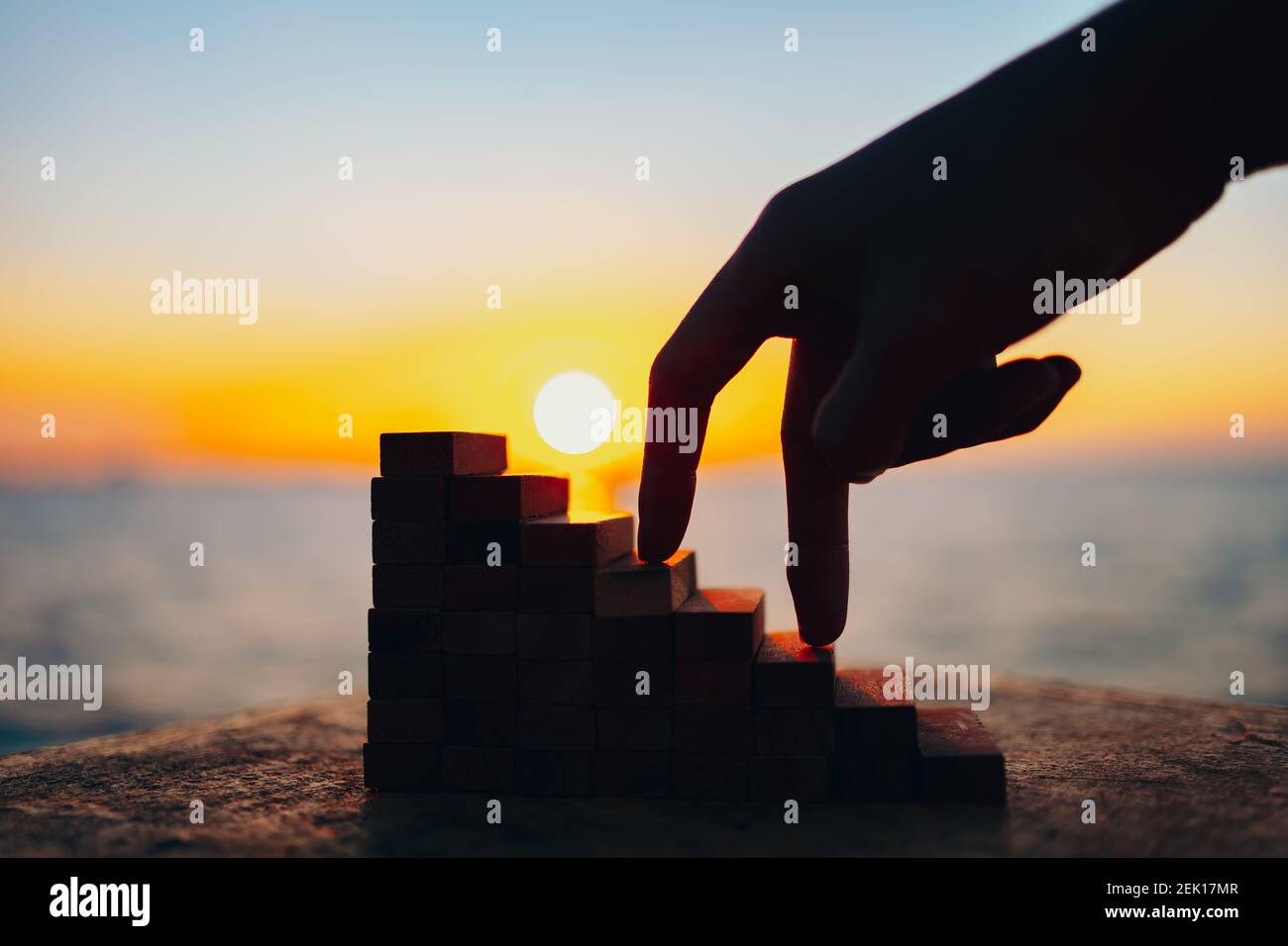 finger like a person stepping up wood block stacking as step stair and ...