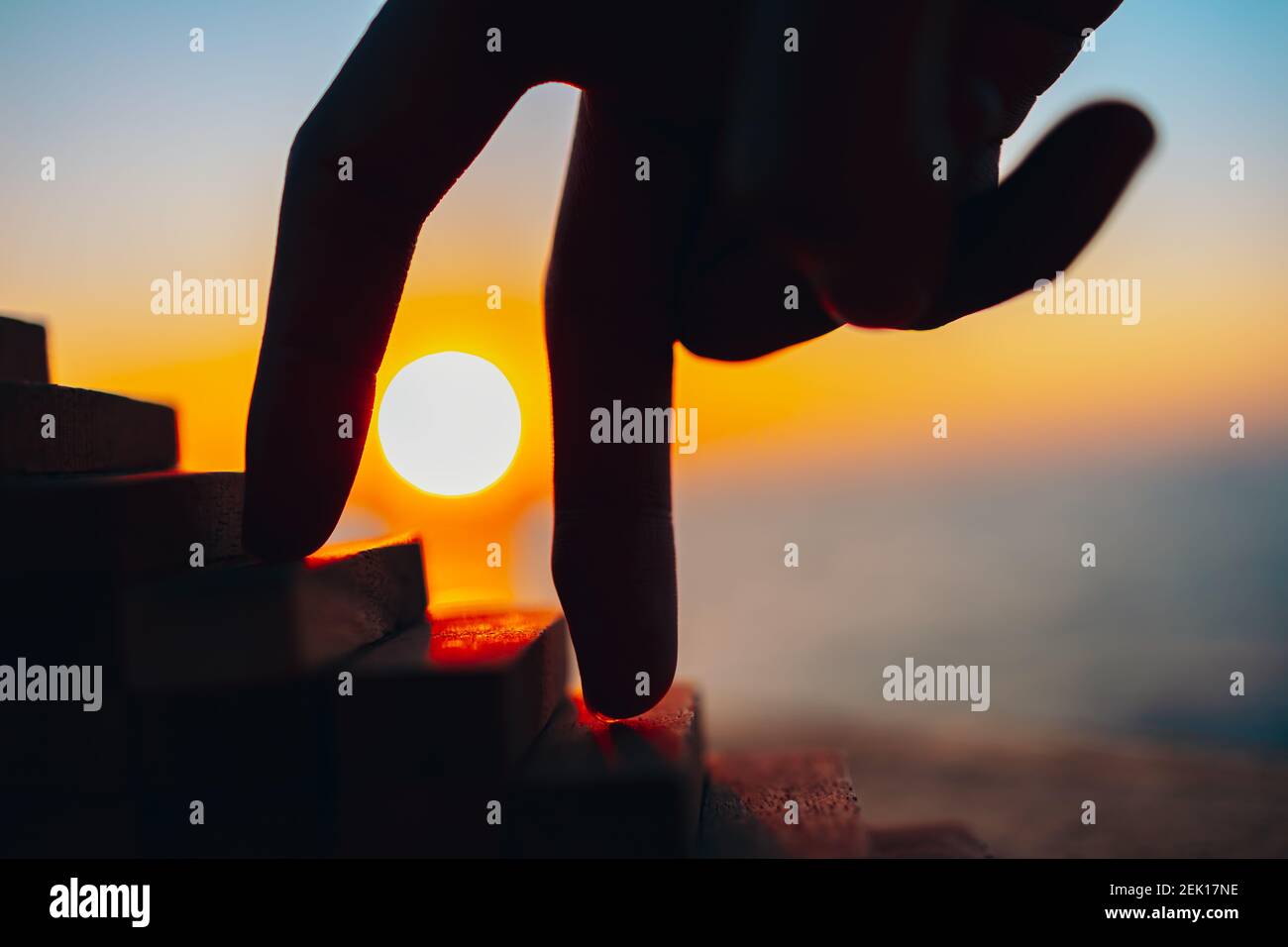 finger like a person stepping up wood block stacking as step stair and ...