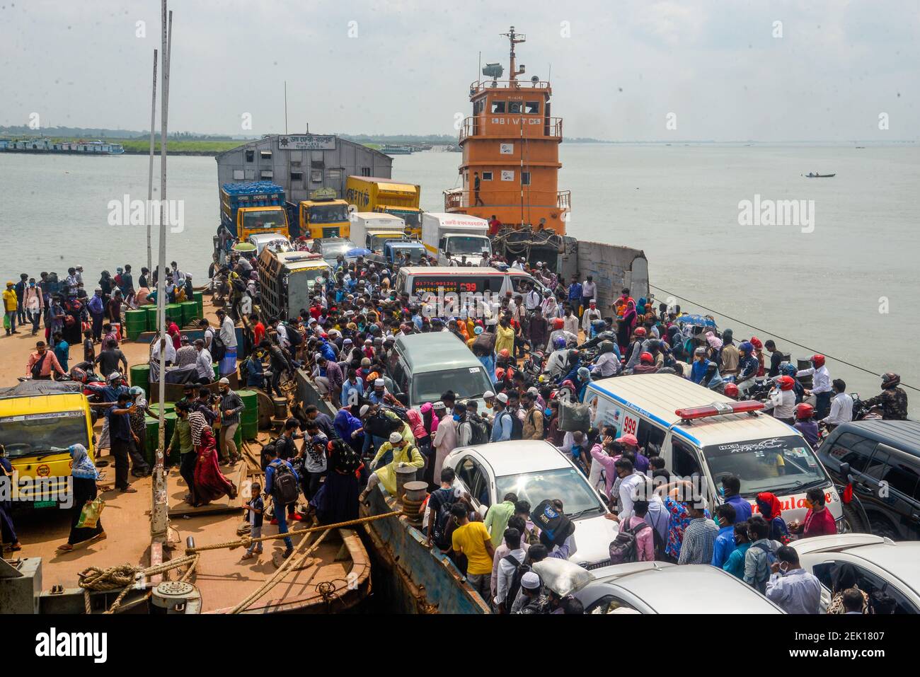 A ferry full of migrant garment workers arrives at Mawa ferry ghat as ...