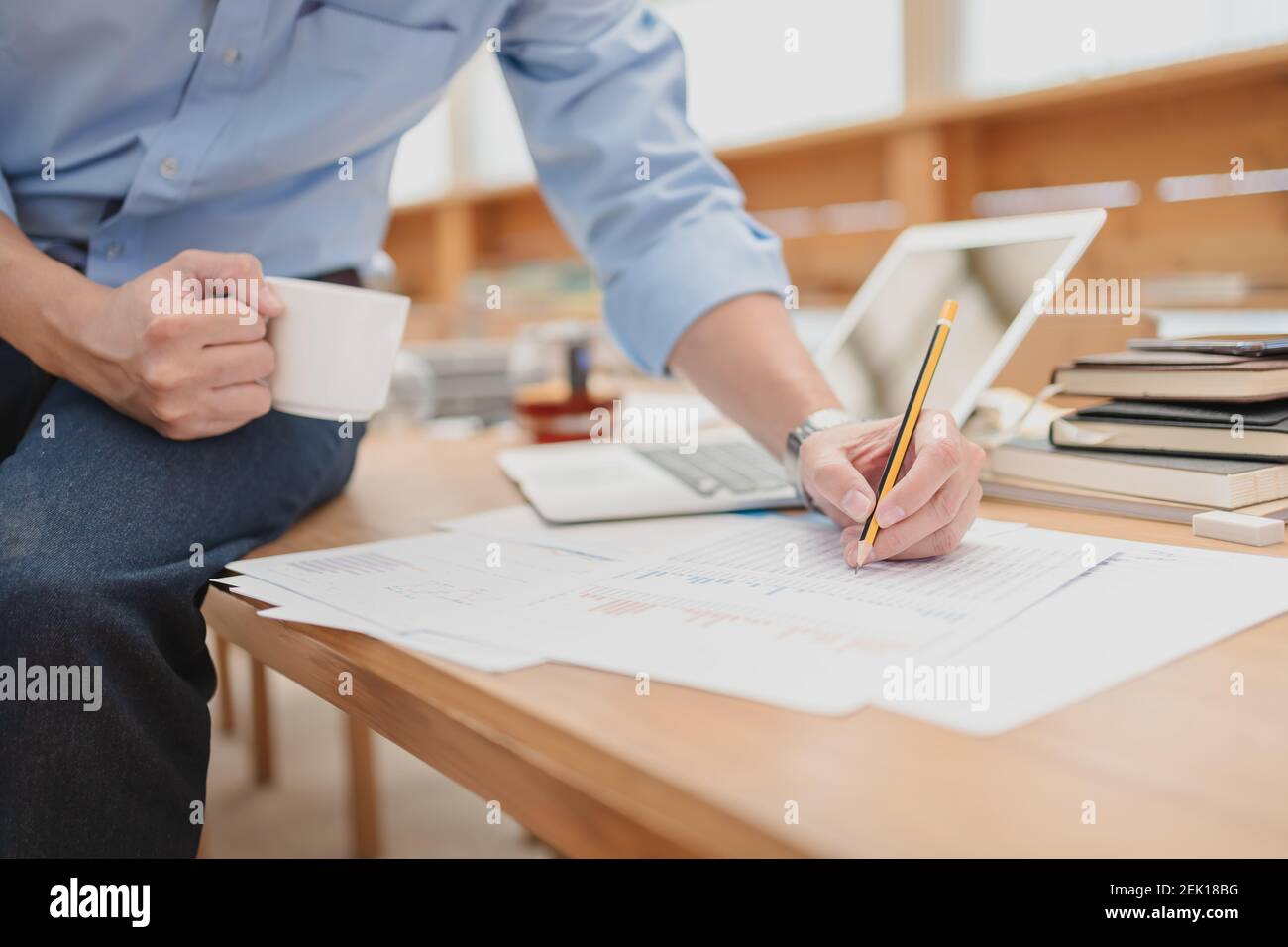 businessman using pencil checking document data calculator for ...