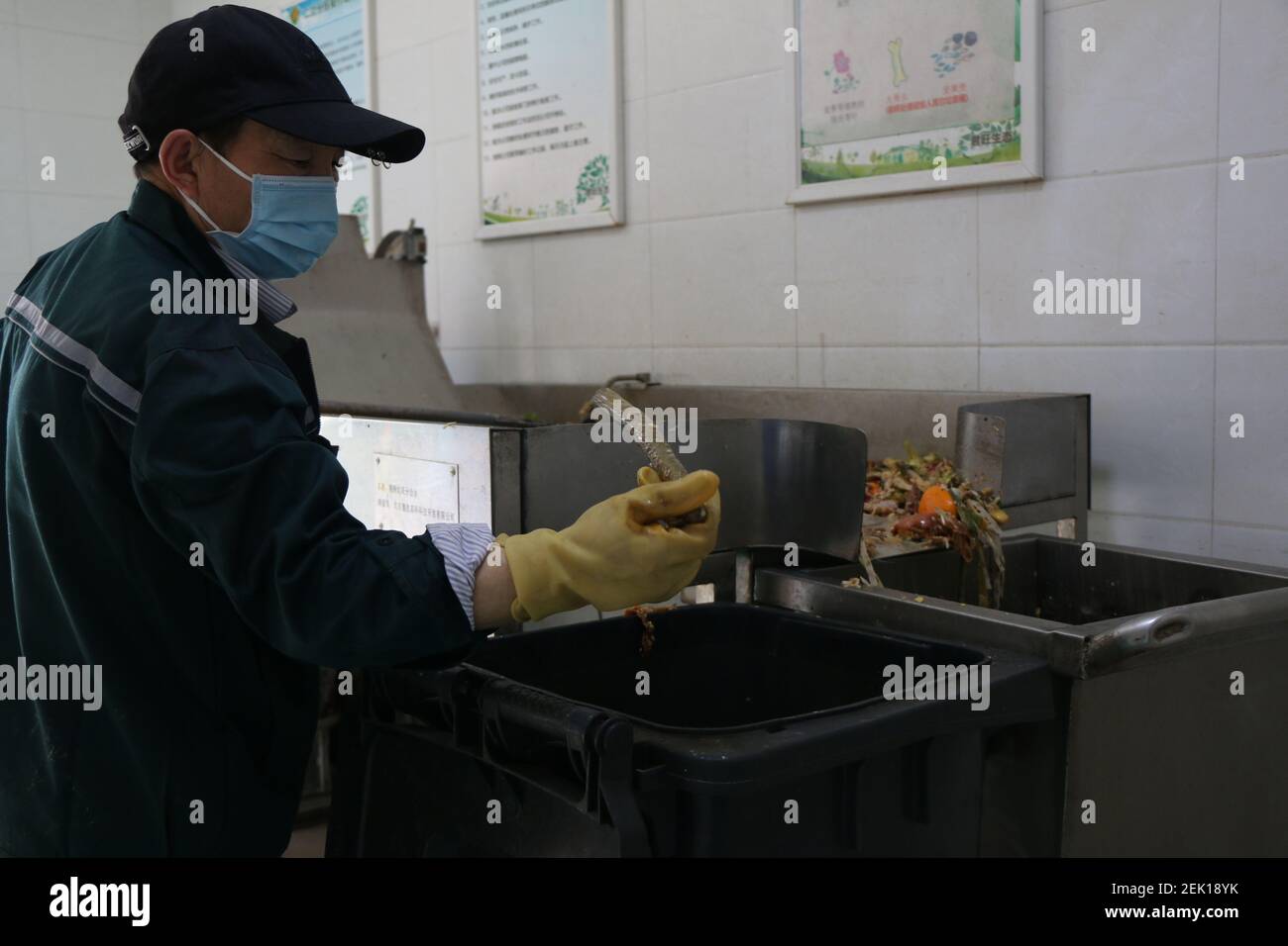 A garbage sorting staff disposes garbage in Xicheng district in Beijing ...