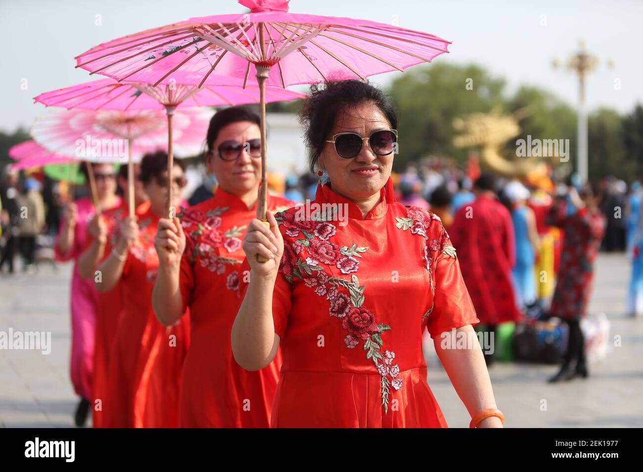 People dressed in traditional Chinese cheongsam doing square dancing at ...