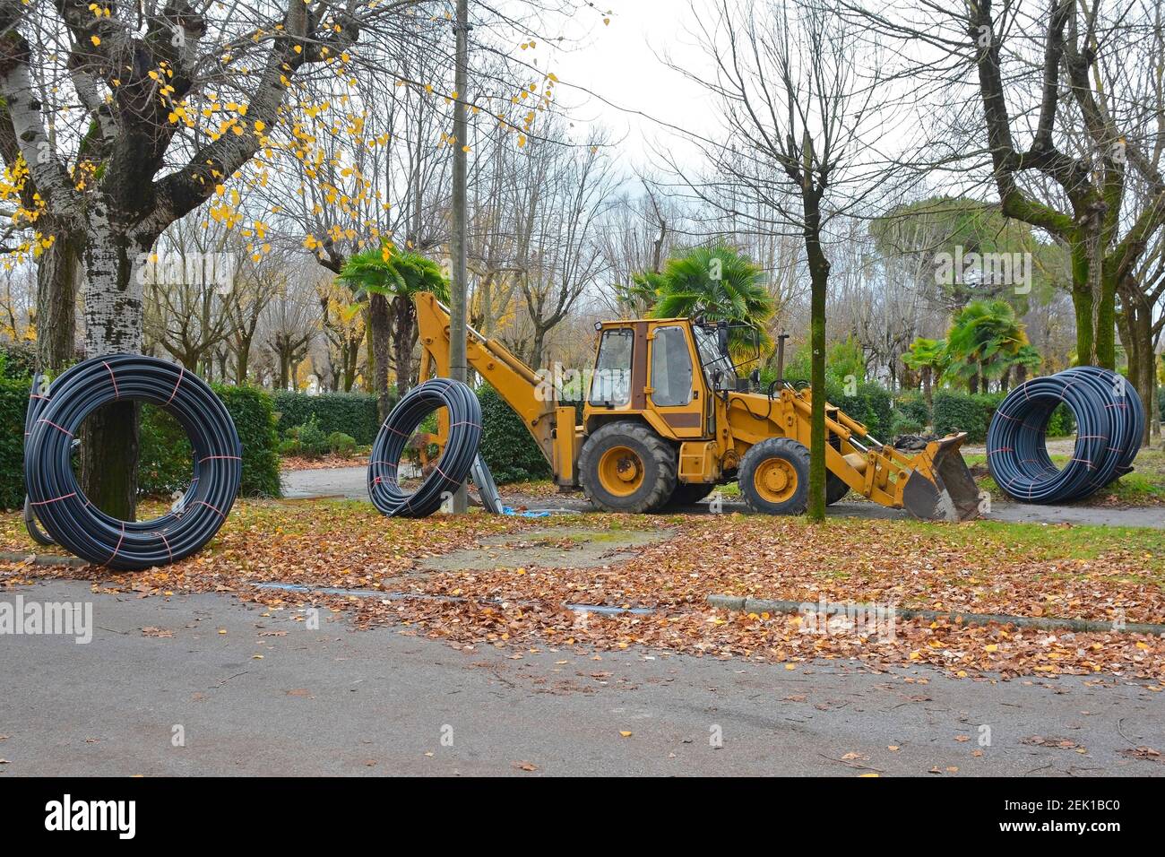 A backhoe loader with rock bucket and mud loader and flexible black ...