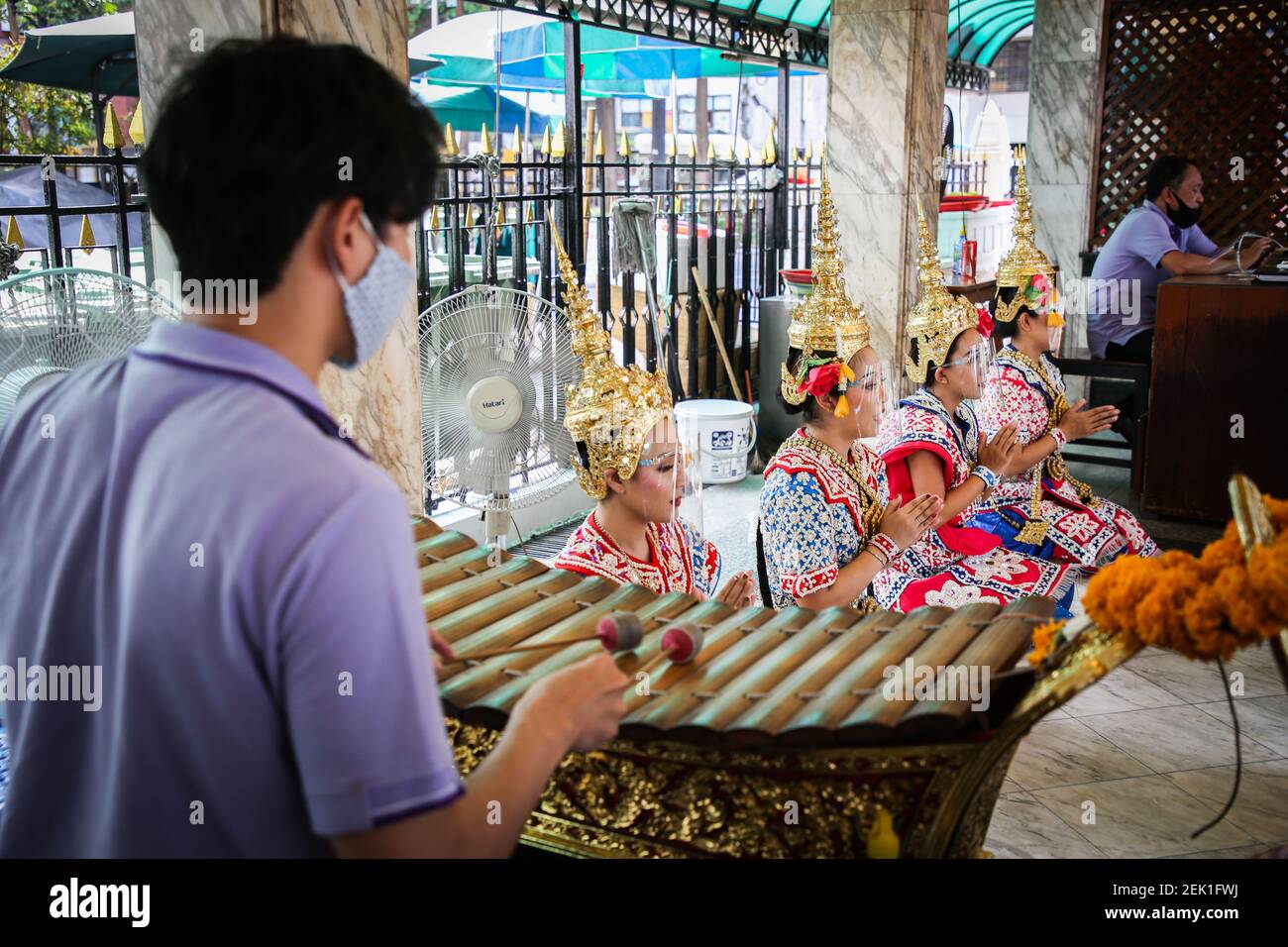 A man seen playing traditional xylophone at the Erawan Shrine in ...