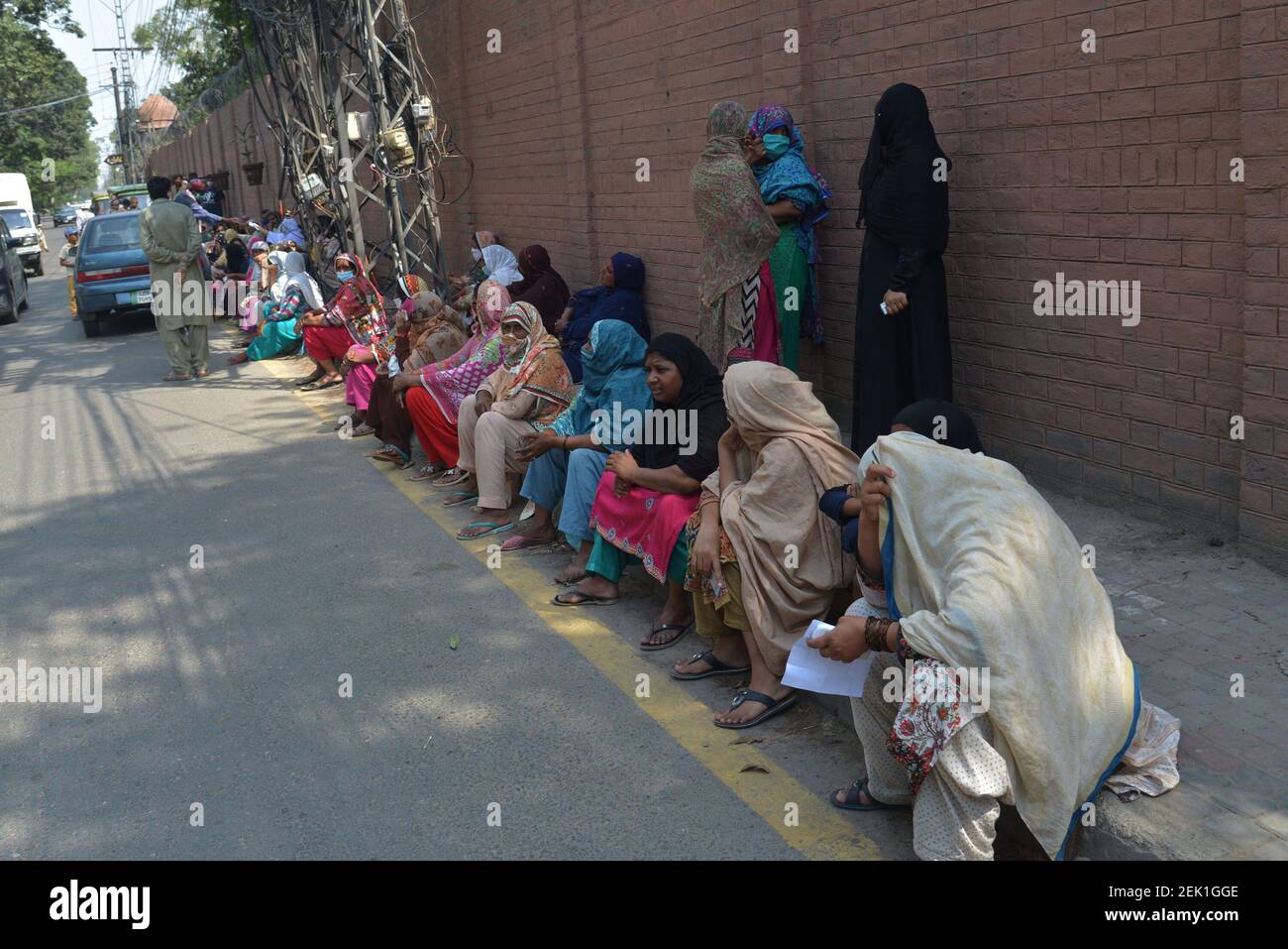 A large numbers of deserving poor women sitting on Davis Road side as ...